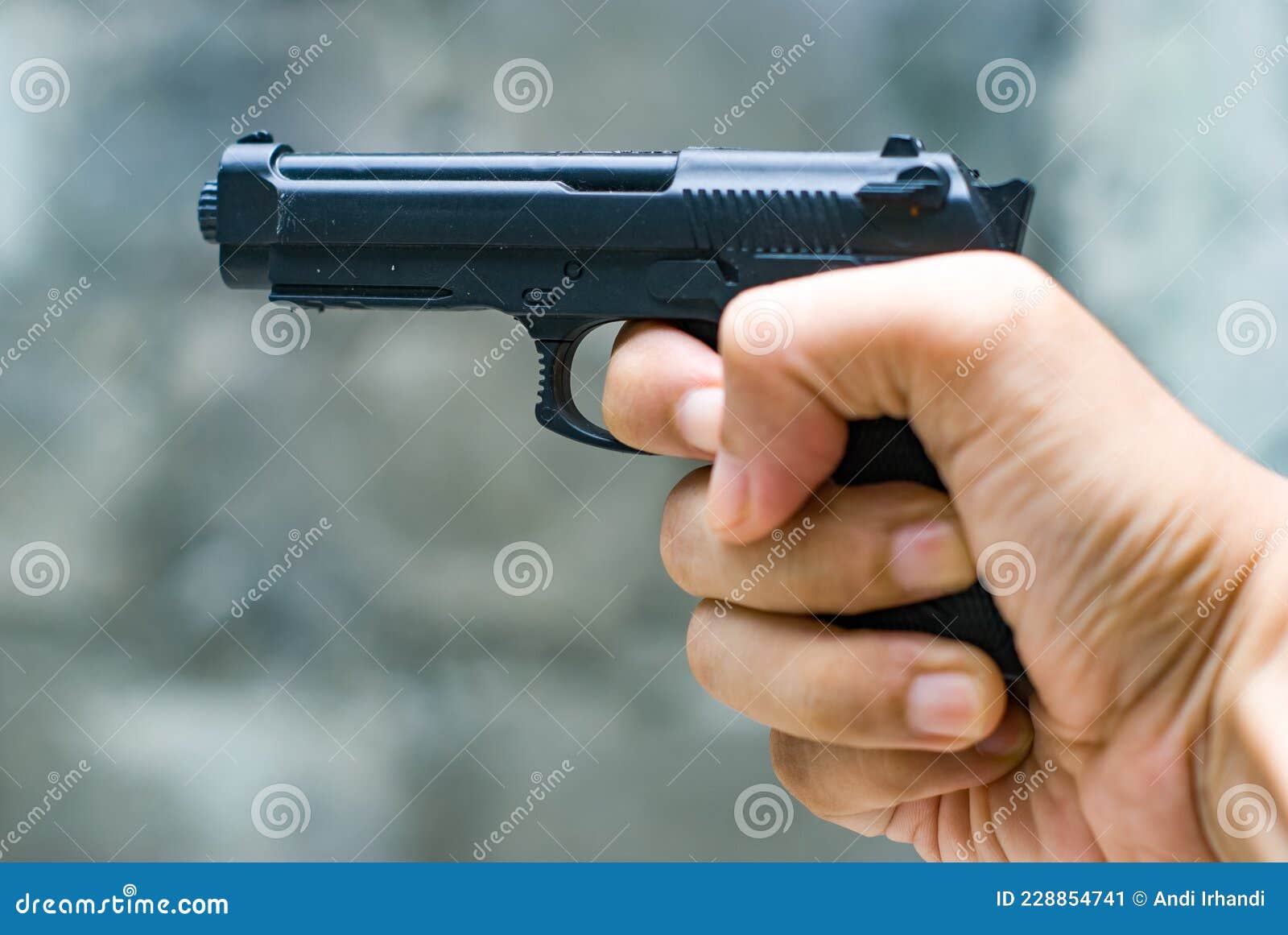 Hand grab and hold the gun stock image. Image of hand - 228854741