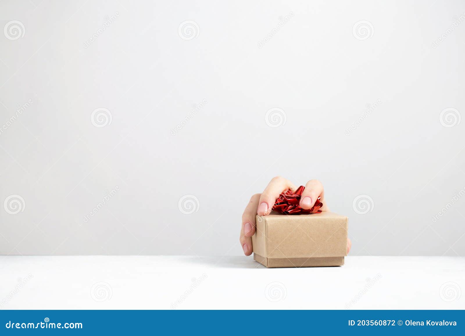 A hand is grabbing a gift stock photo. Image of object - 203560872