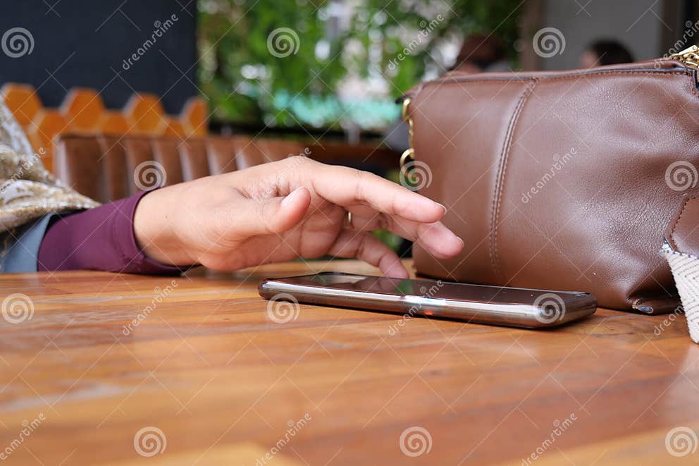 A Hand Grabbing and Picking Up Mobile Phone on the Table. Stock Photo ...