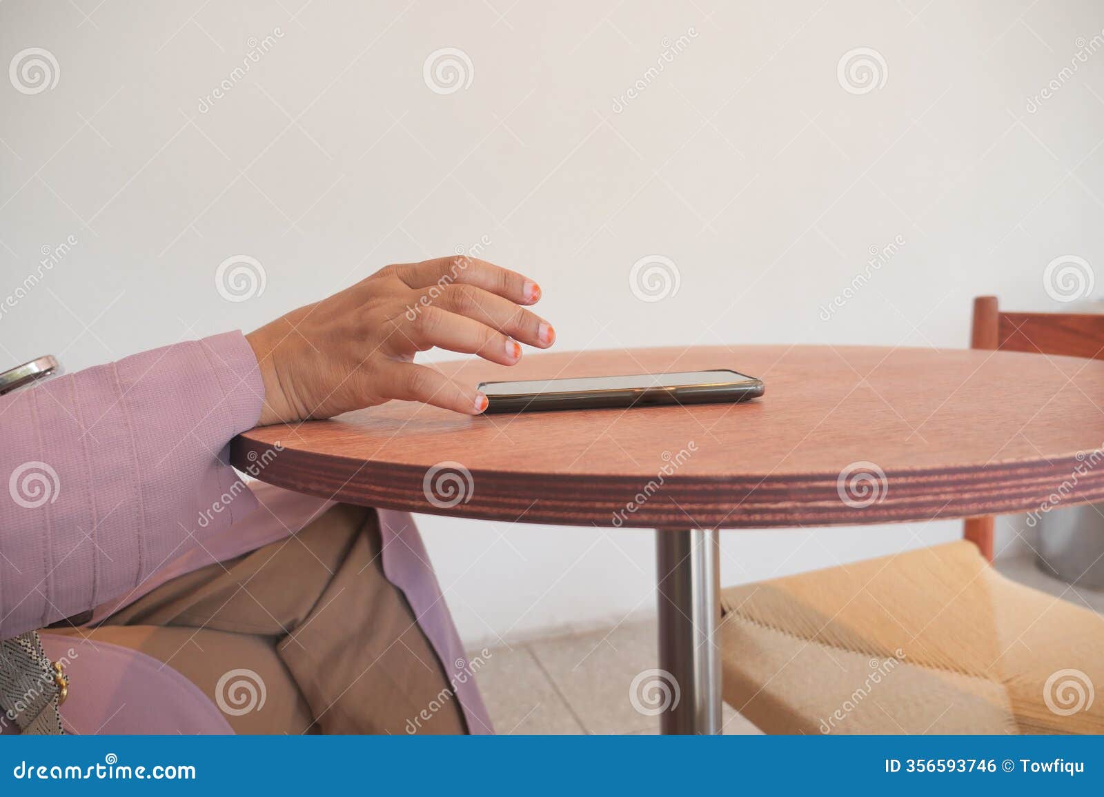 A Hand Grabbing and Picking Up Mobile Phone on the Table. Stock Photo ...