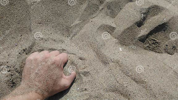 Hand Grabbing Sand on a Sunny Day Stock Photo - Image of sunny, sand ...
