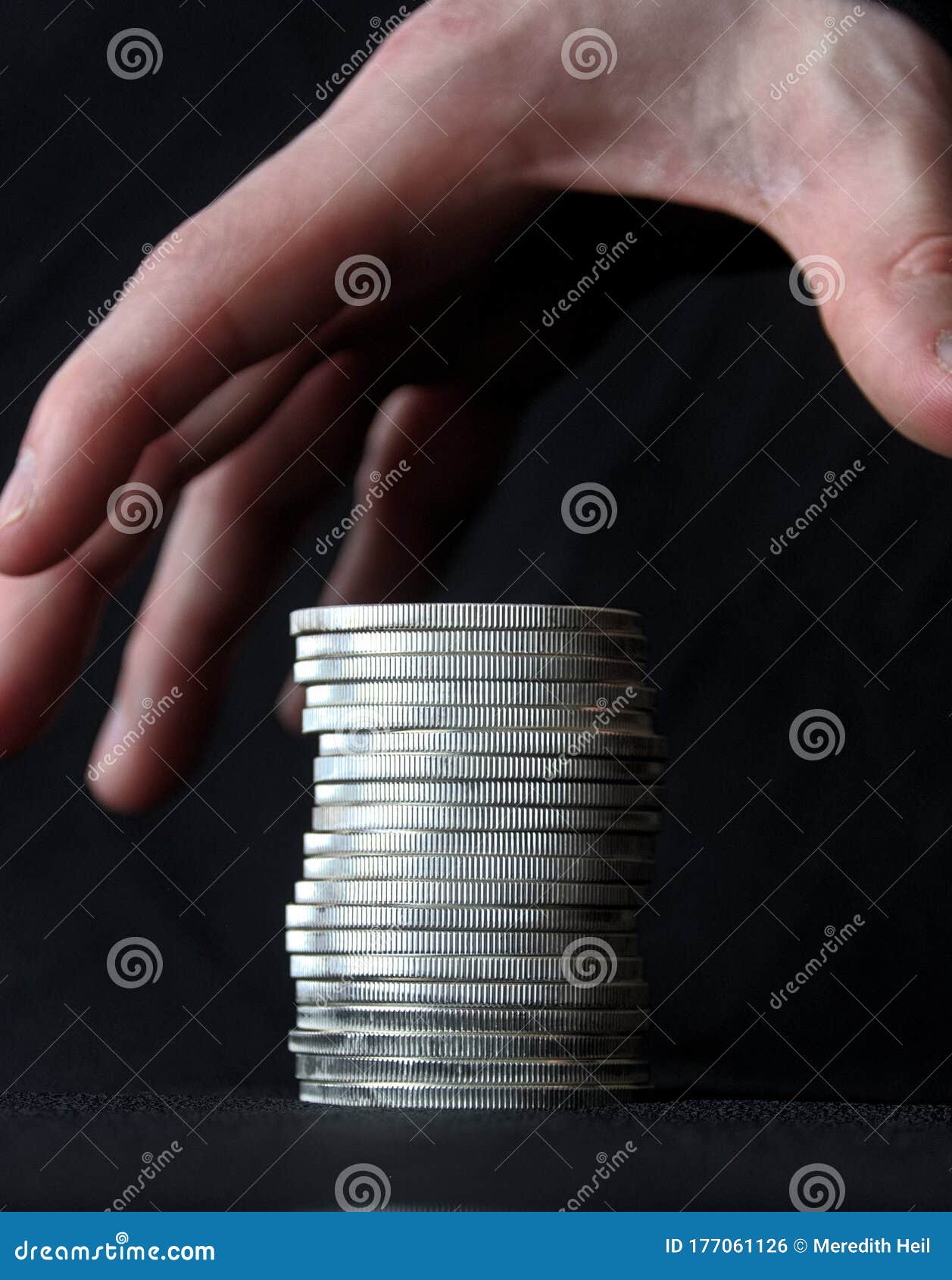 Hand Grasping for a Stack of Silver Coins Stock Photo - Image of ...
