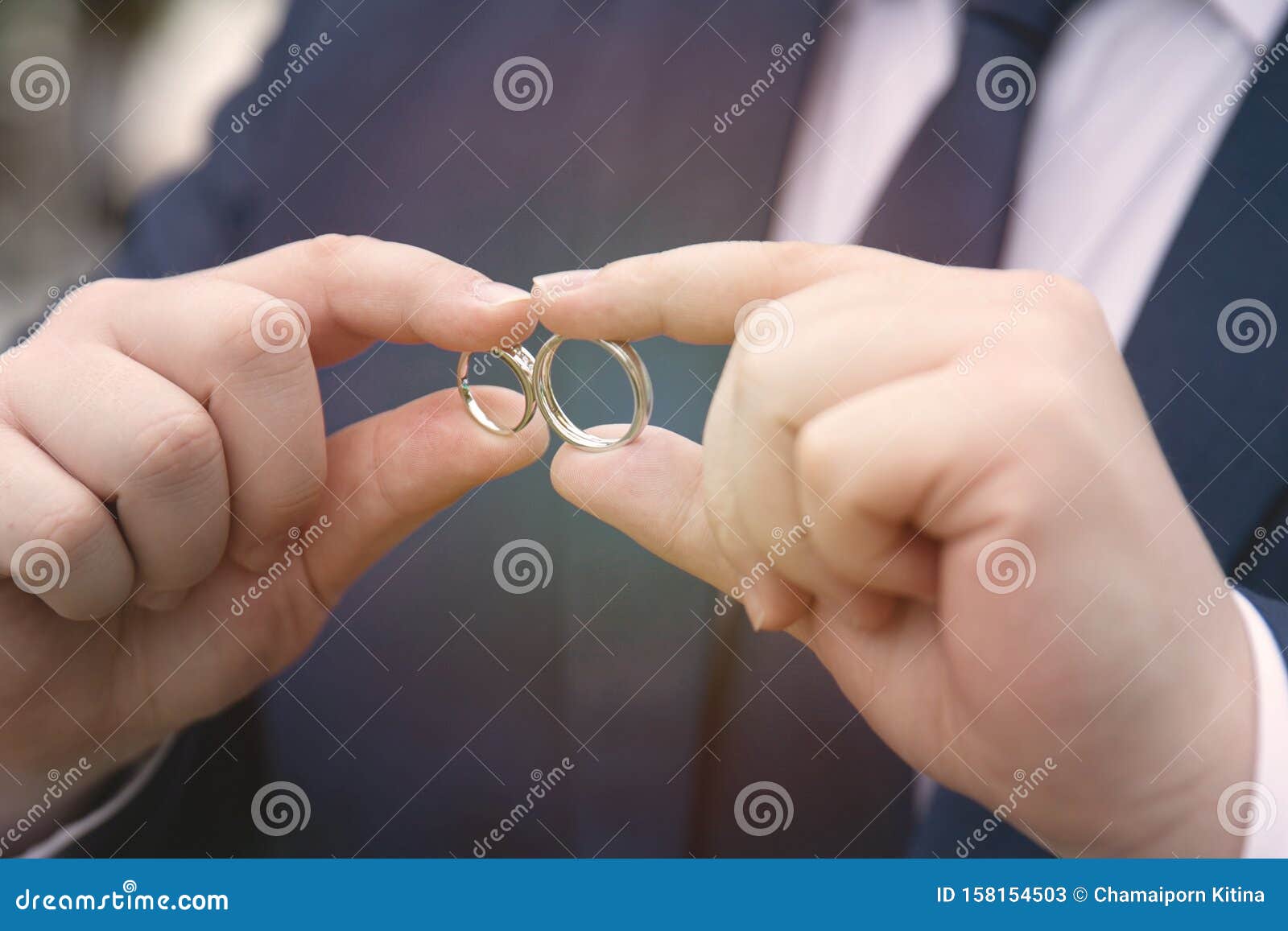 Hand of Groom Hold Two Engagement or Wedding Ring Stock Image - Image ...