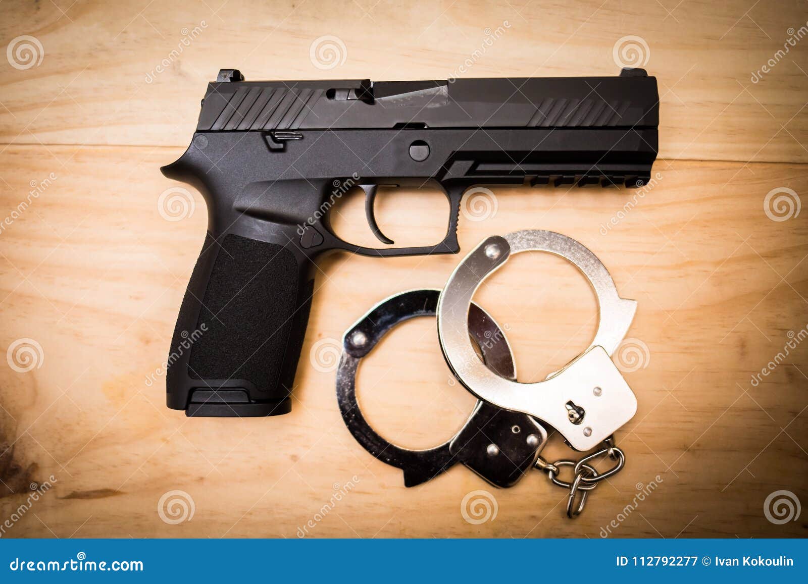 Hand Gun with Hand Cuffs on Wooden Surface Stock Image - Image of ...