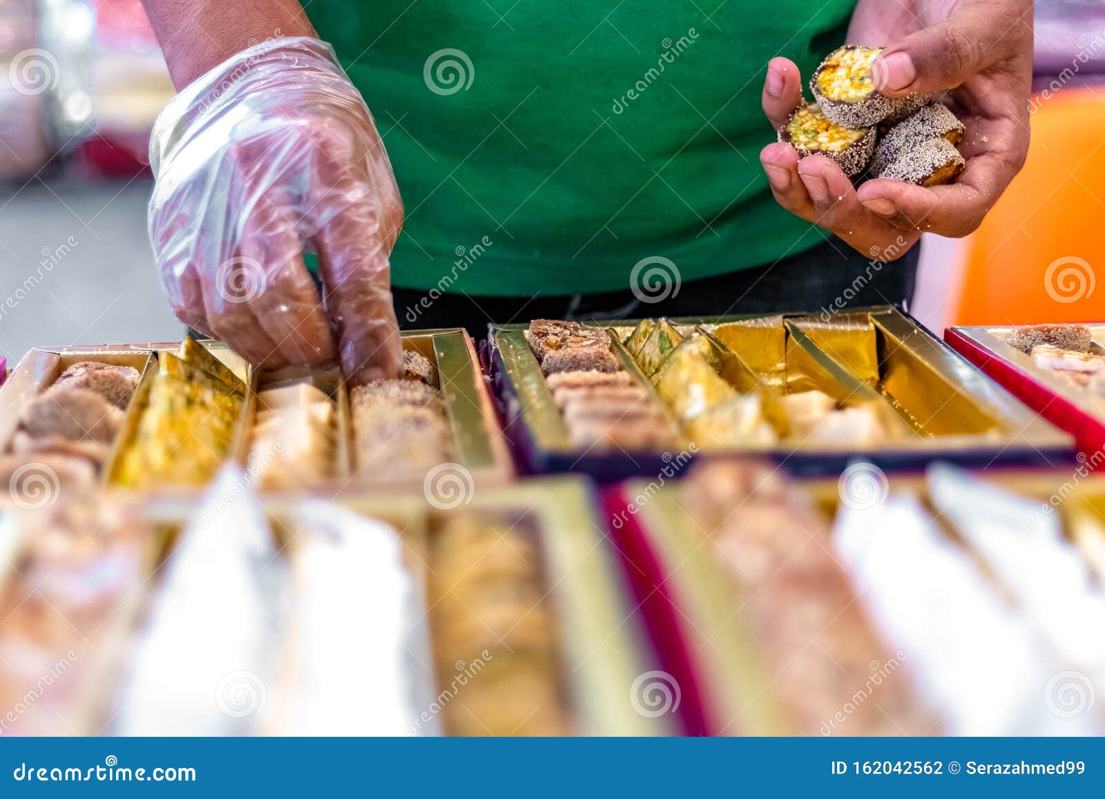Hand of a Guy Arranging Sweets in a Box for Diwali Festival Stock Photo ...
