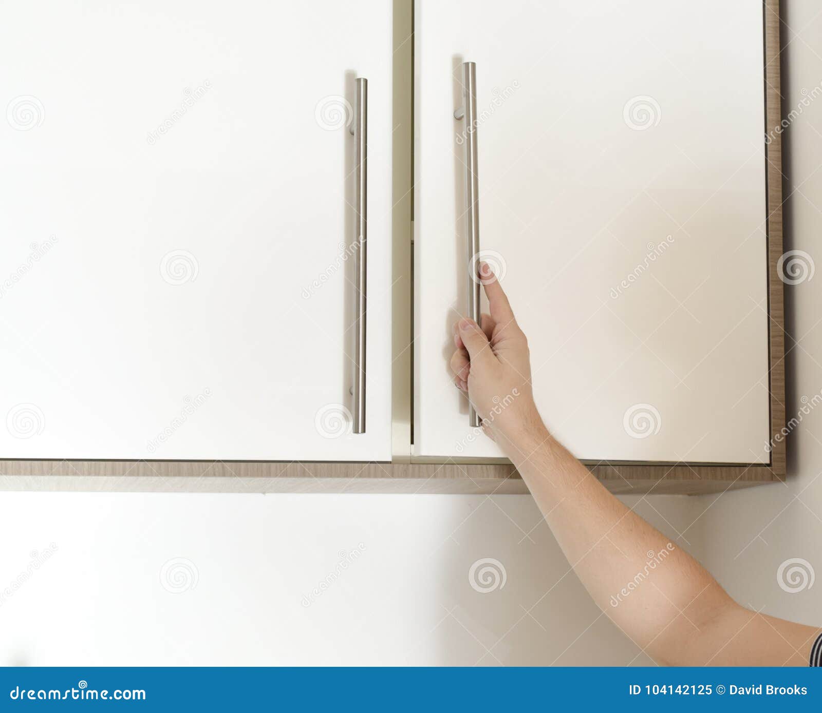 Hand on Handle Opening Cabinet Stock Image - Image of door, cups: 104142125