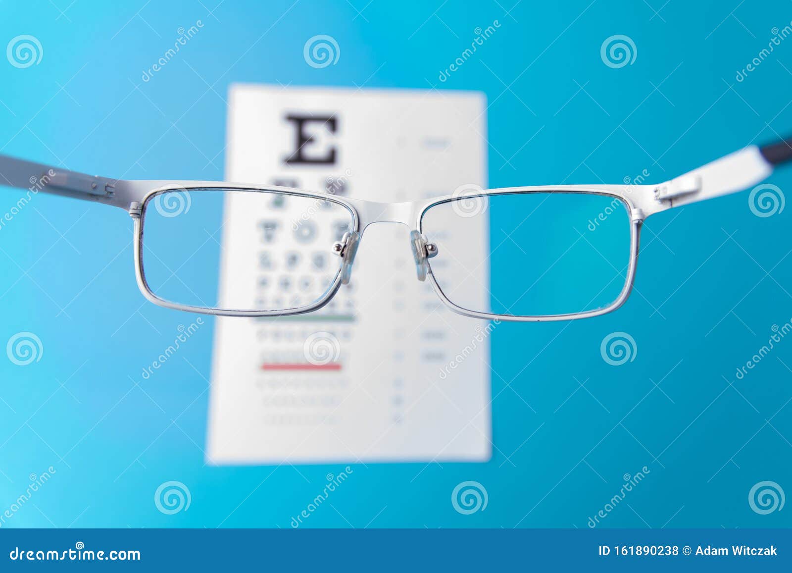 Hand-held Glasses, View of the Snellen Chart. Blue Background Stock ...
