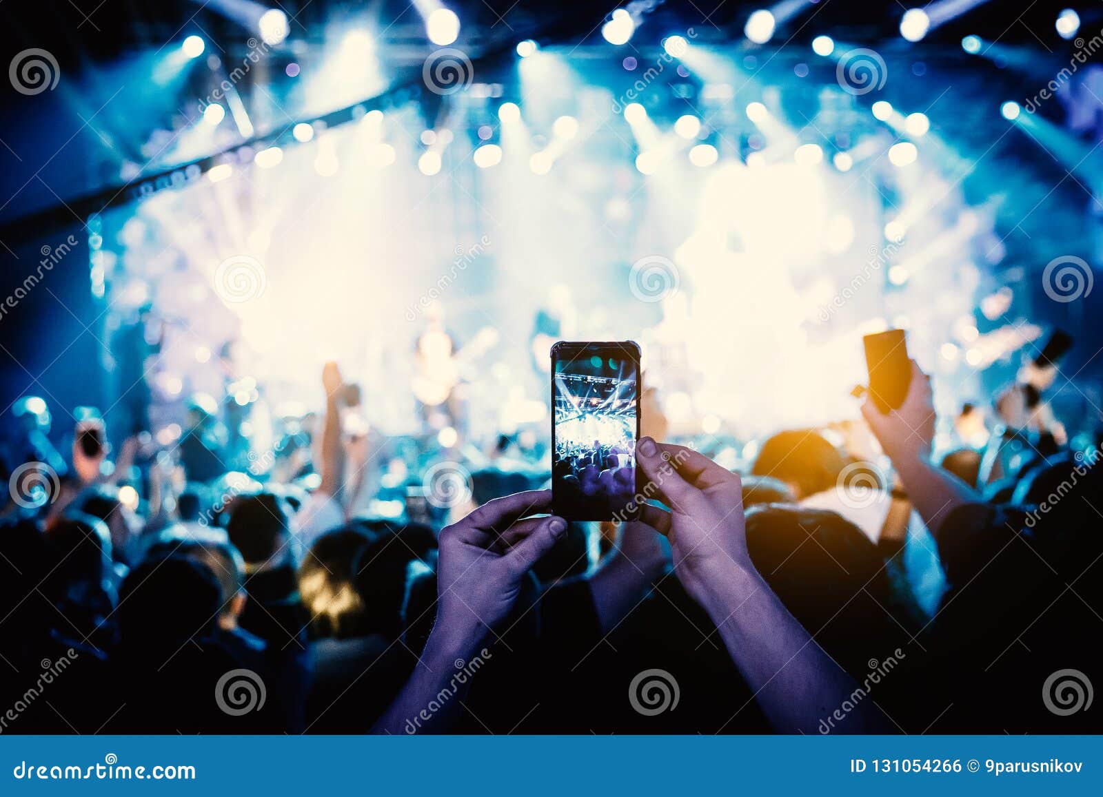 Hand Held Smart Phone Filming a Concert. Stock Photo - Image of bokeh ...