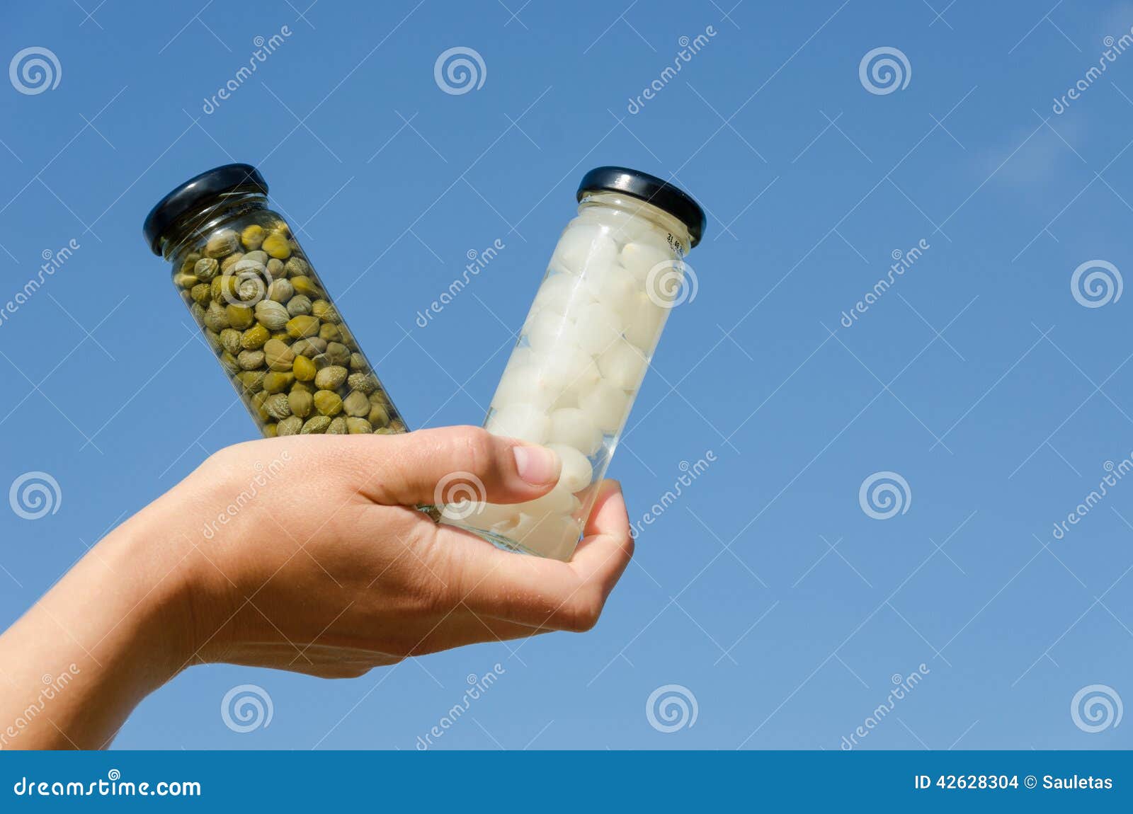 Hand Hold Caper Garlic Jar on Blue Sky Background Stock Photo - Image ...