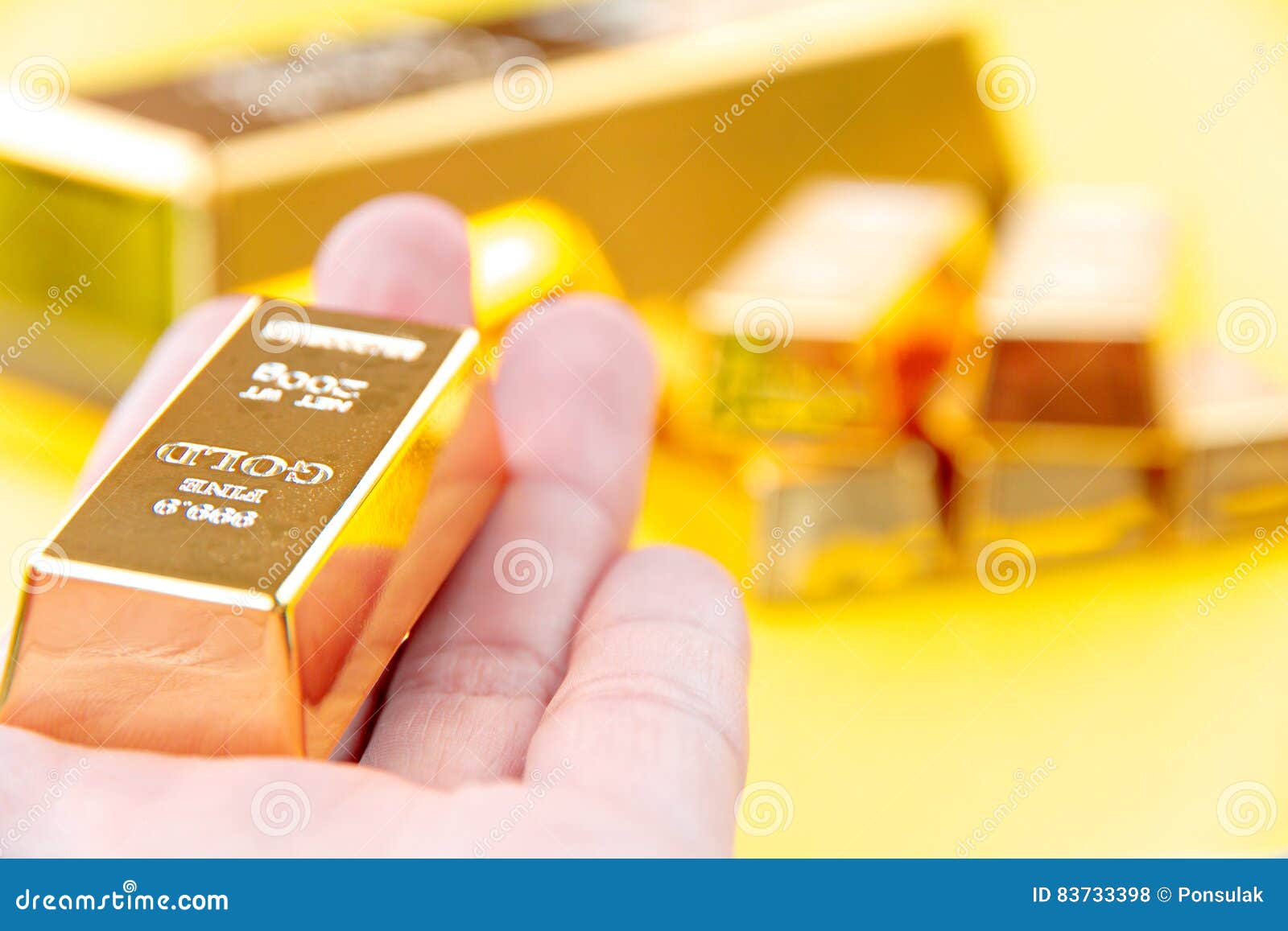 Hand hold gold bars stock photo. Image of clash, instrument - 83733398