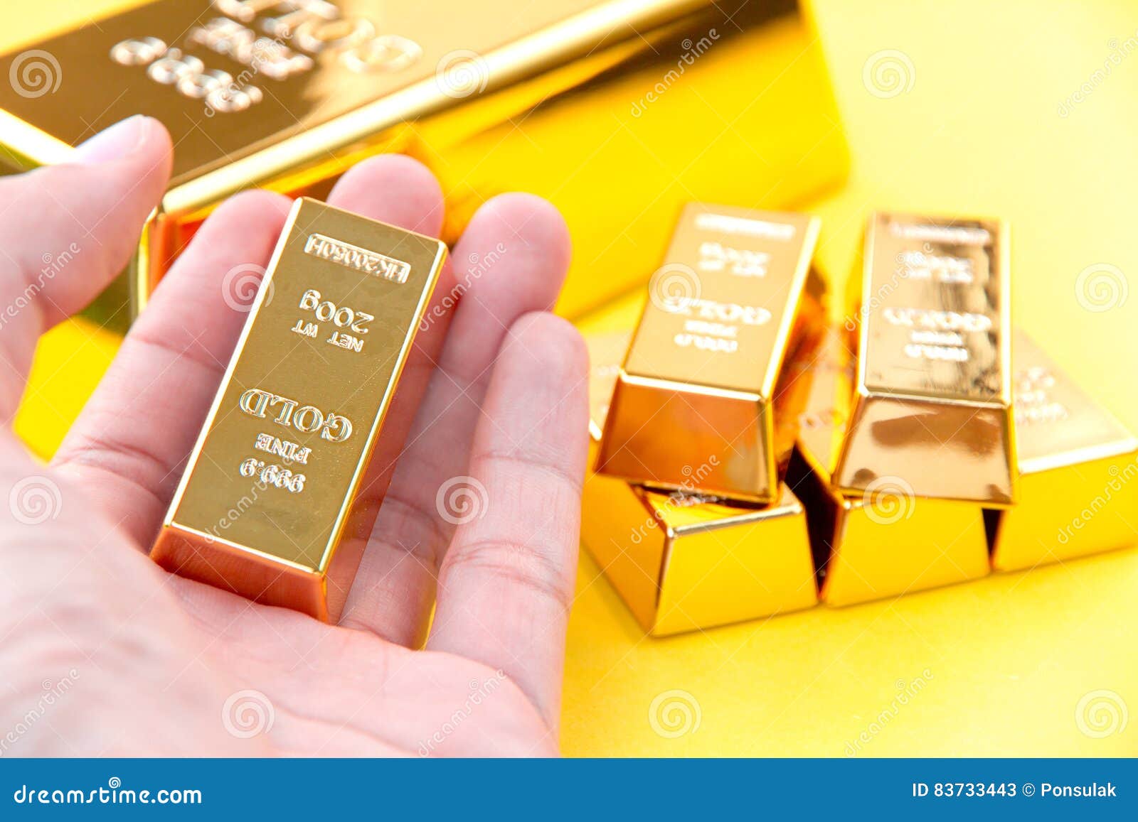 Hand hold gold bars stock image. Image of bead, financial - 83733443