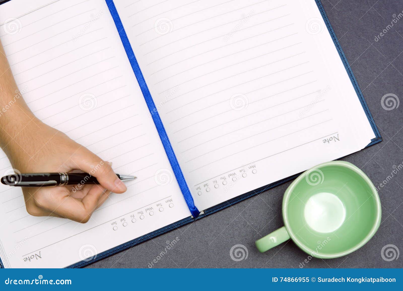 Hand Hold a Pen and Write on a Book with a Cup Stock Image - Image of ...