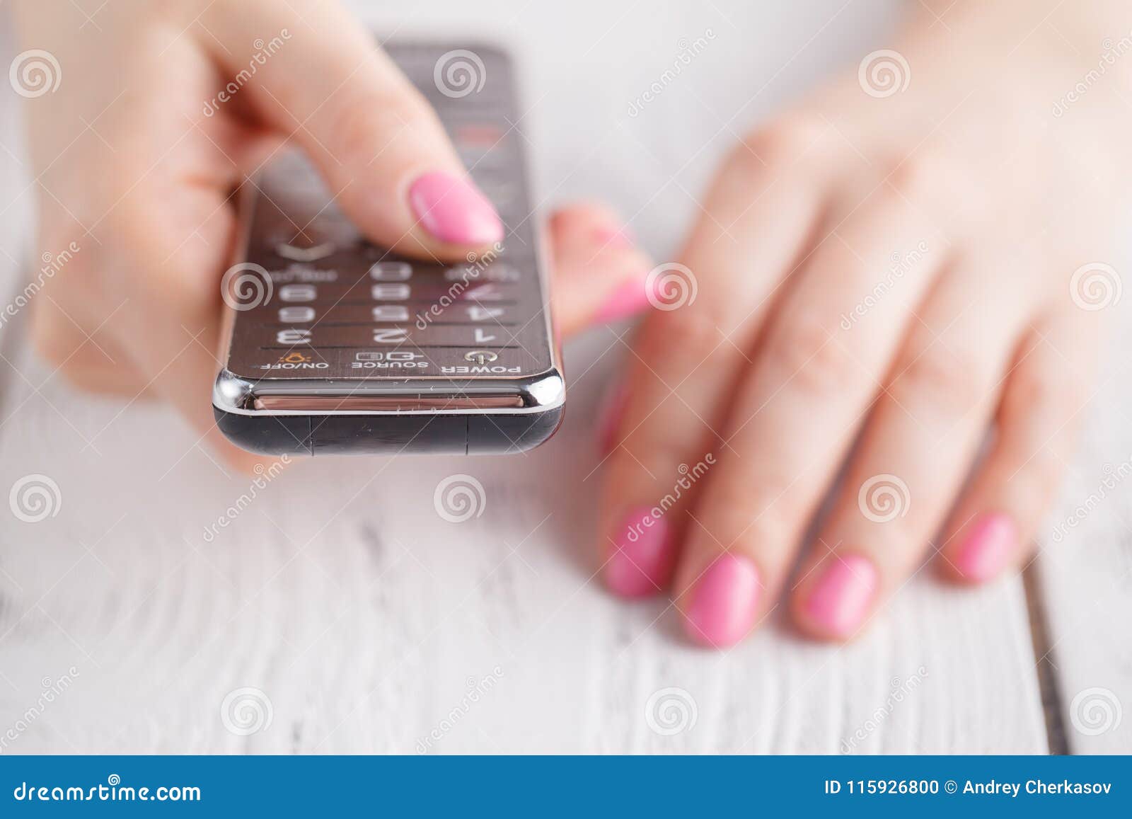 Hand hold remote control stock photo. Image of home - 115926800