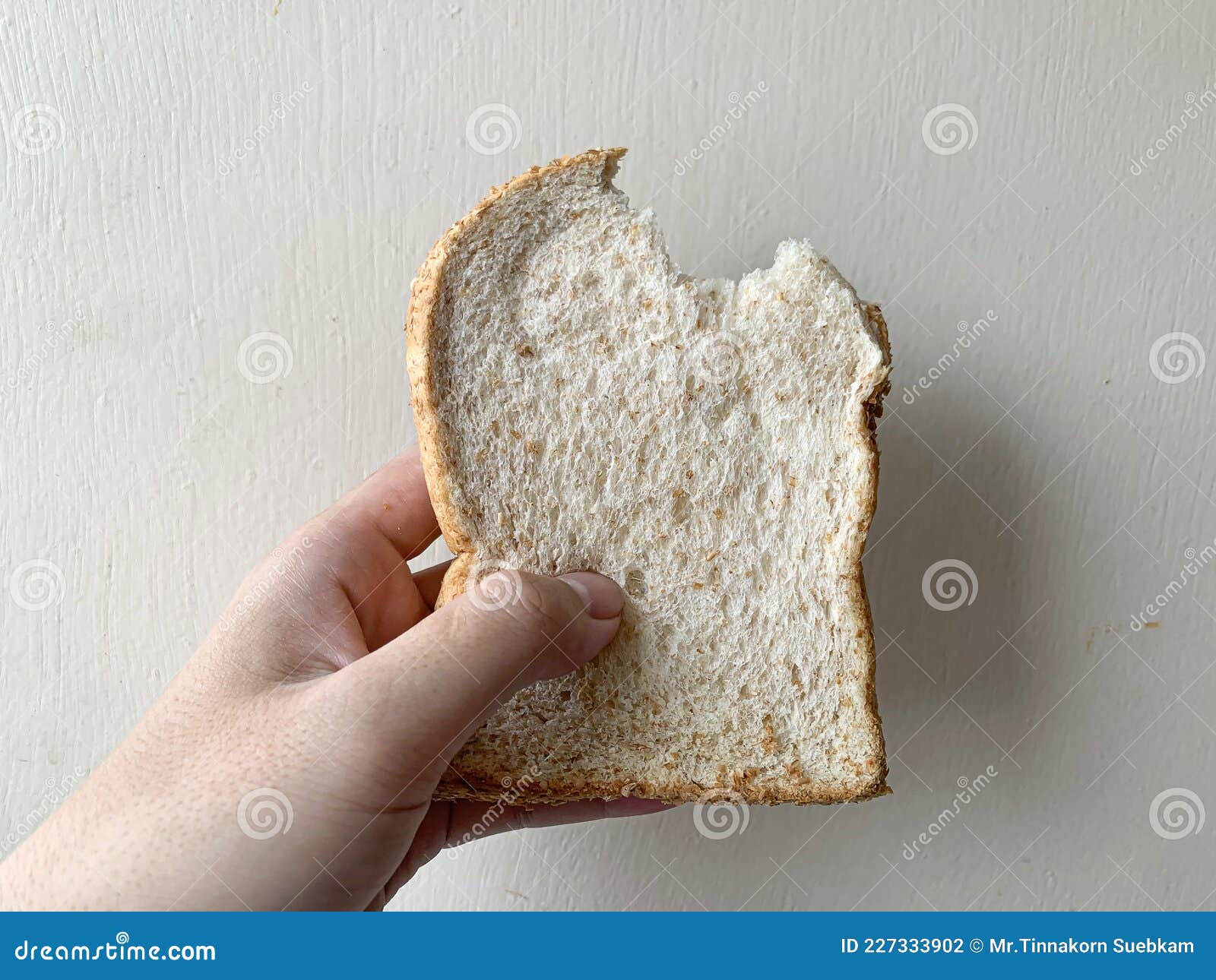 Hand Hold Slices of Bread with Bite Marks on White Background Stock ...