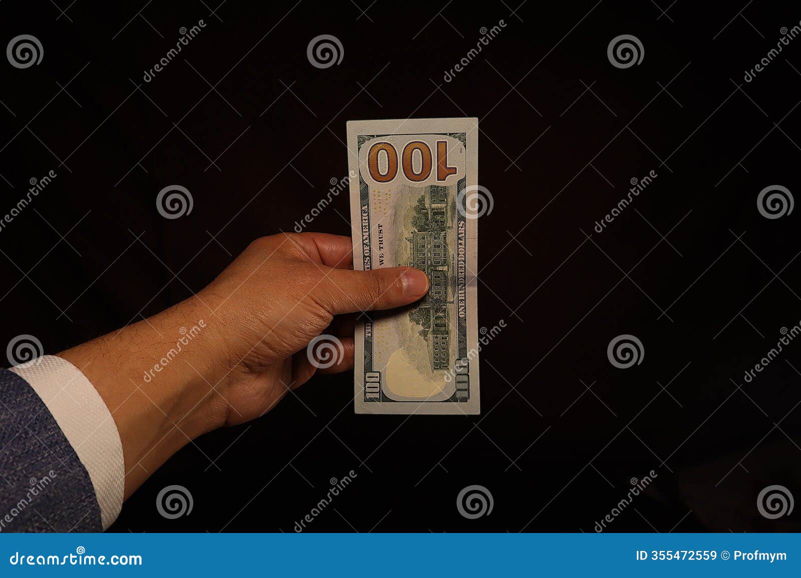 Hand Holding Back Side of $100 U.S. Bill Isolated on Black Background ...