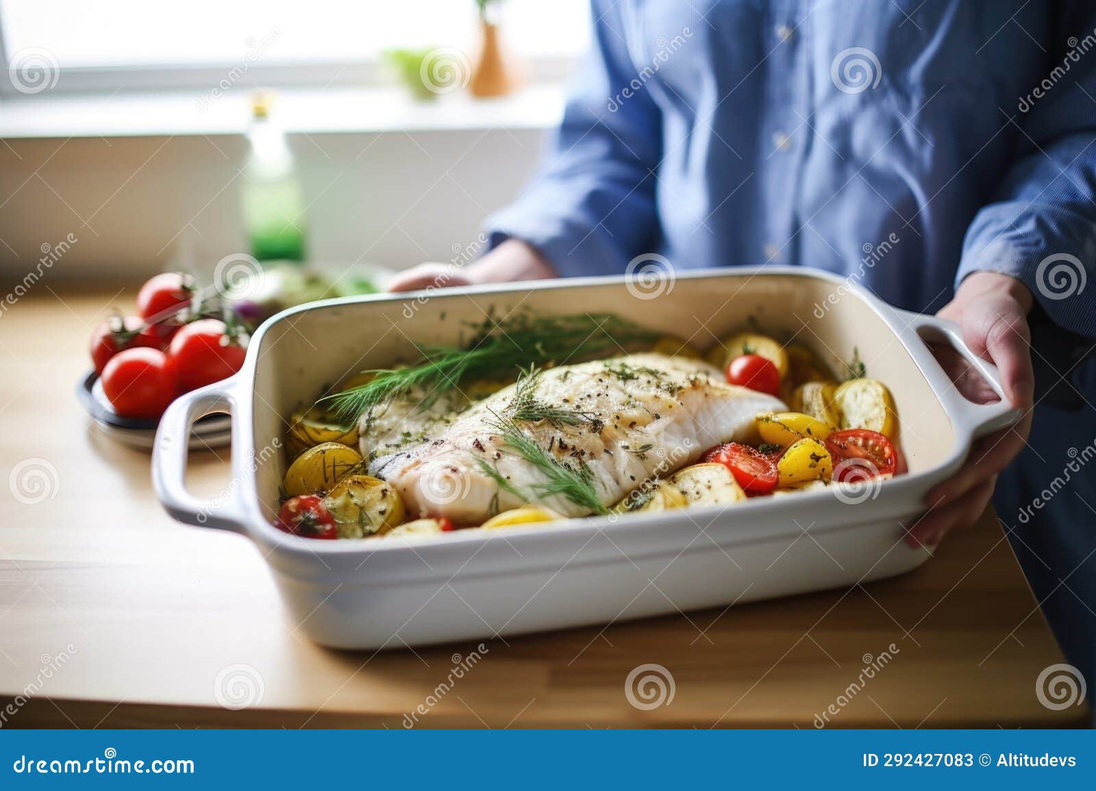Hand Holding a Baking Dish with Cod in a Cozy Kitchen Setting Stock ...
