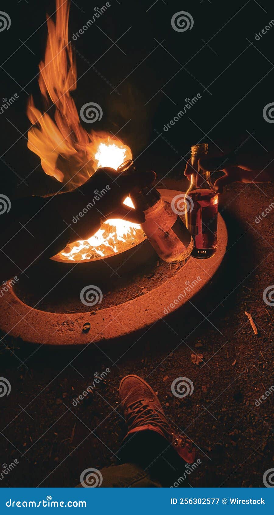 Hand Holding a Beer with Camp Fire Stock Image - Image of holding ...