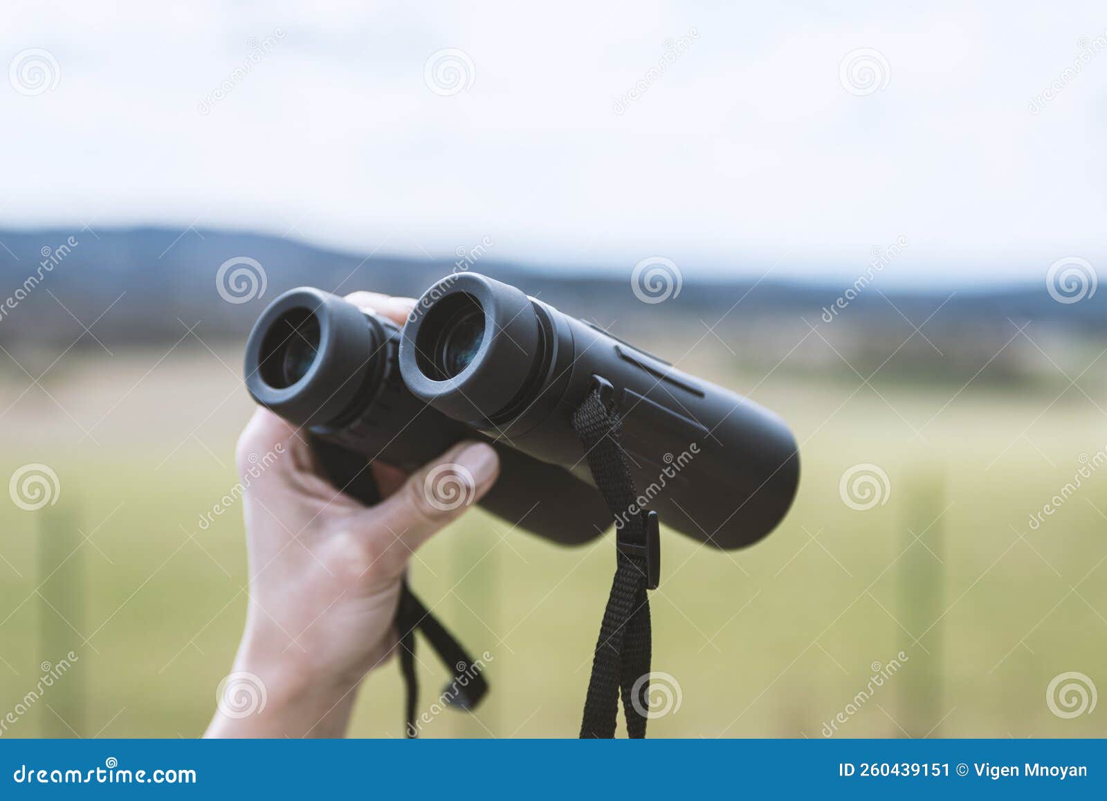 Hand holding a binoculars stock image. Image of lifestyle - 260439151