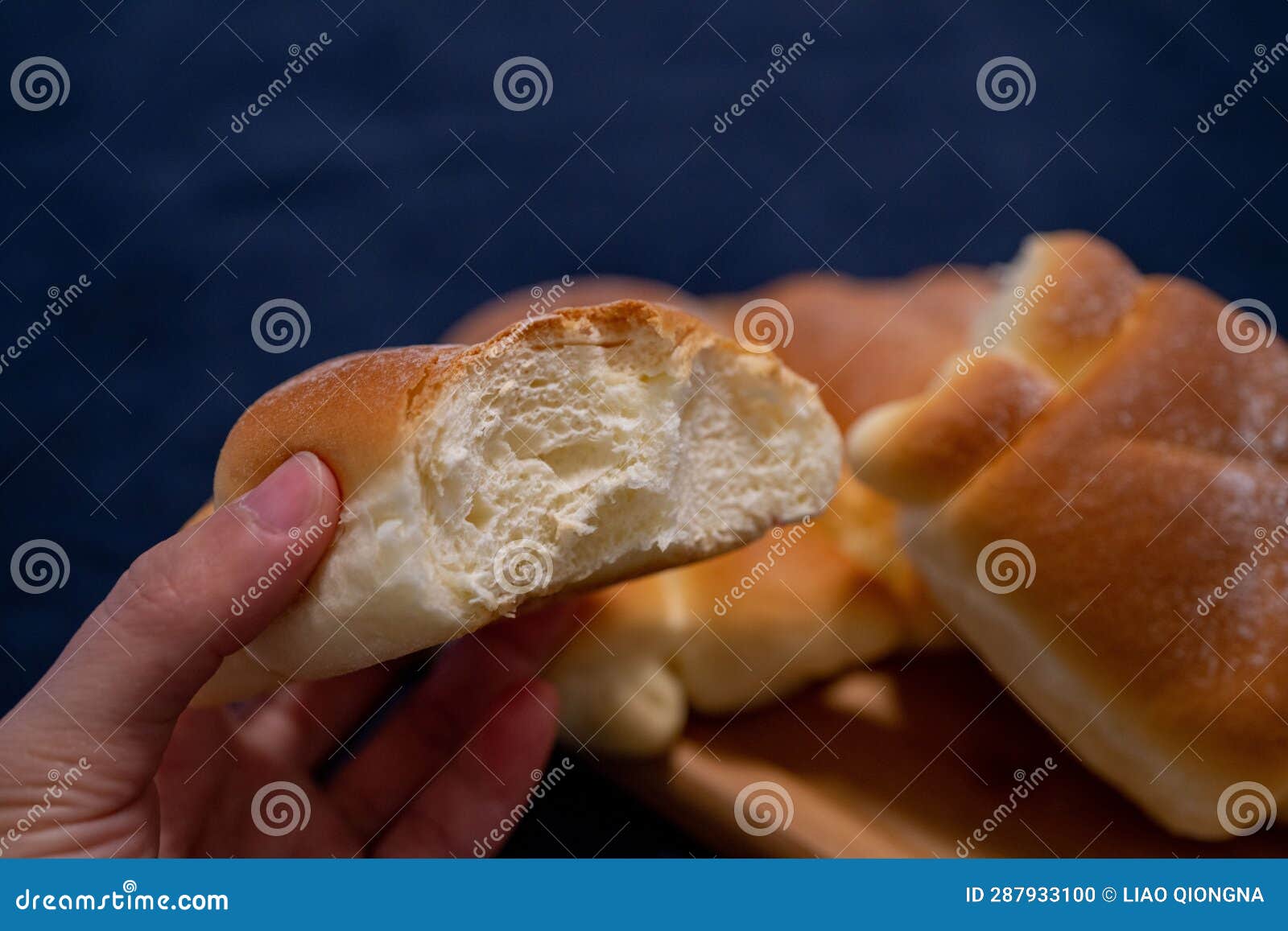 The Hand is Holding a Bitten Bread. Stock Photo - Image of closeup ...