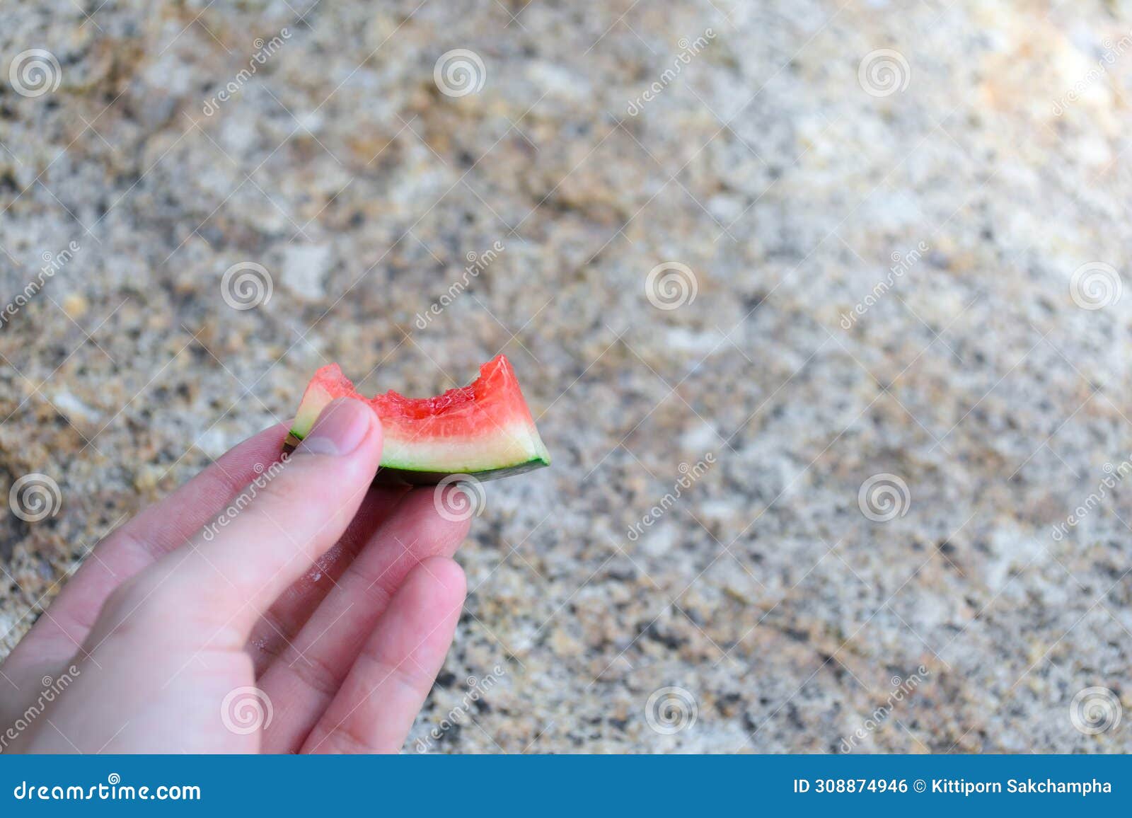 Hand Holding Bitten Watermelon Close-up in Stone Pattern Floor Blurred ...
