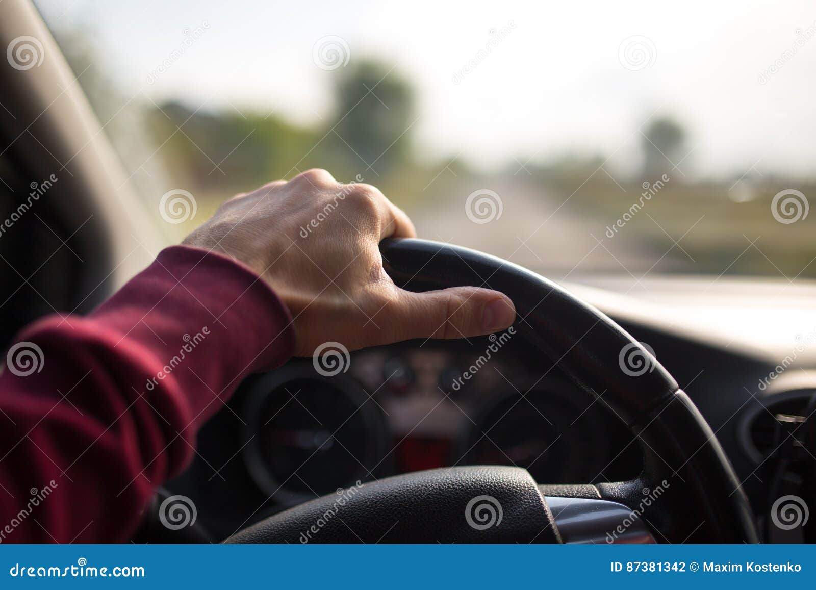 Hand Holding on Black Steering Wheel while Driving in the Car Stock ...