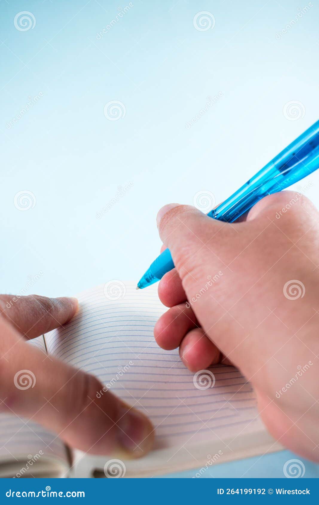 Hand Holding a Blue Pen and Writing on the Paper Against a White ...