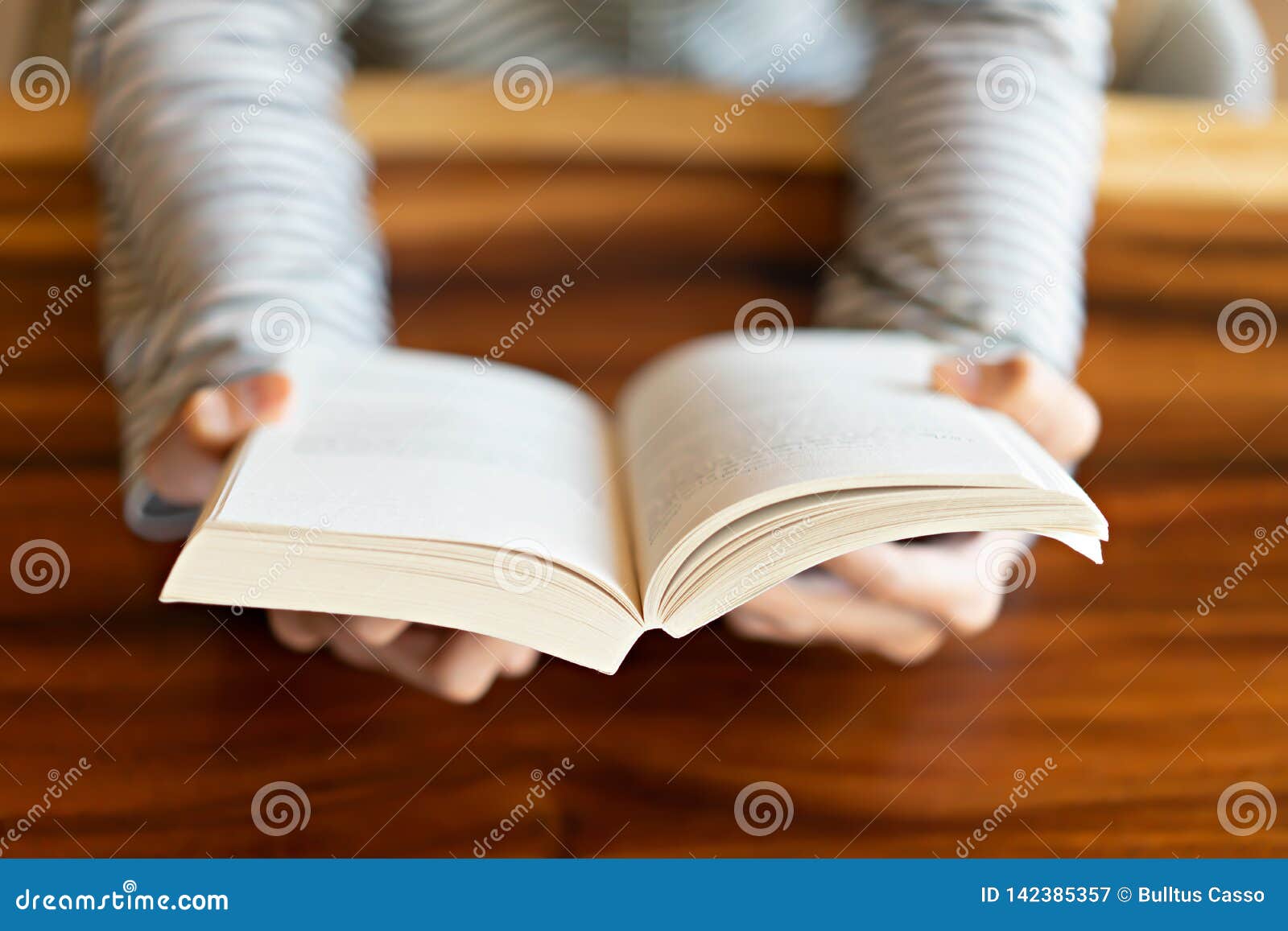 Hand Holding a Book at Home Stock Image - Image of background ...