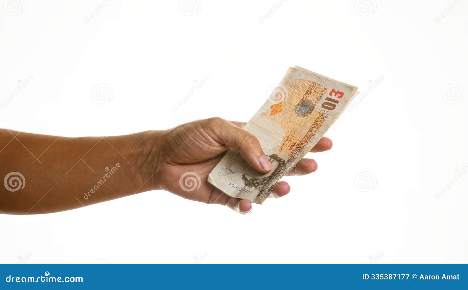 Hand Holding British Pound Notes Against an Isolated White Background ...