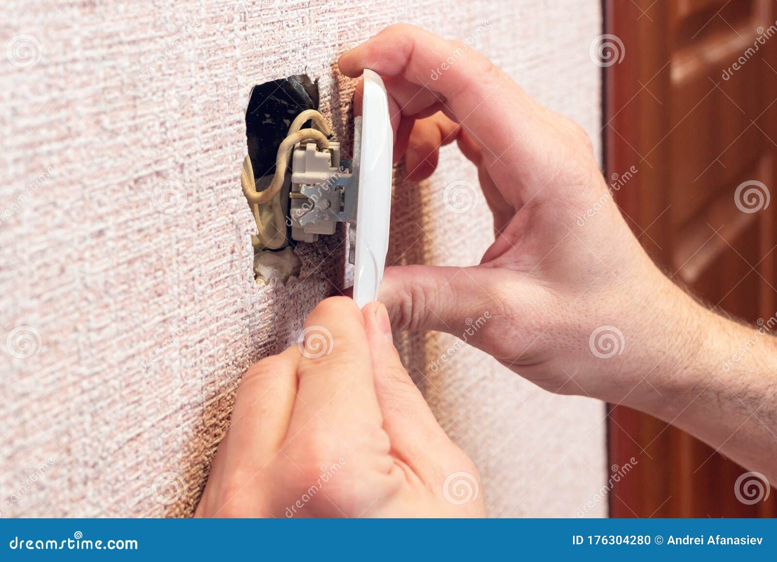 Hand Holding a Broken Outlet, Risking Electric Shock Stock Photo ...
