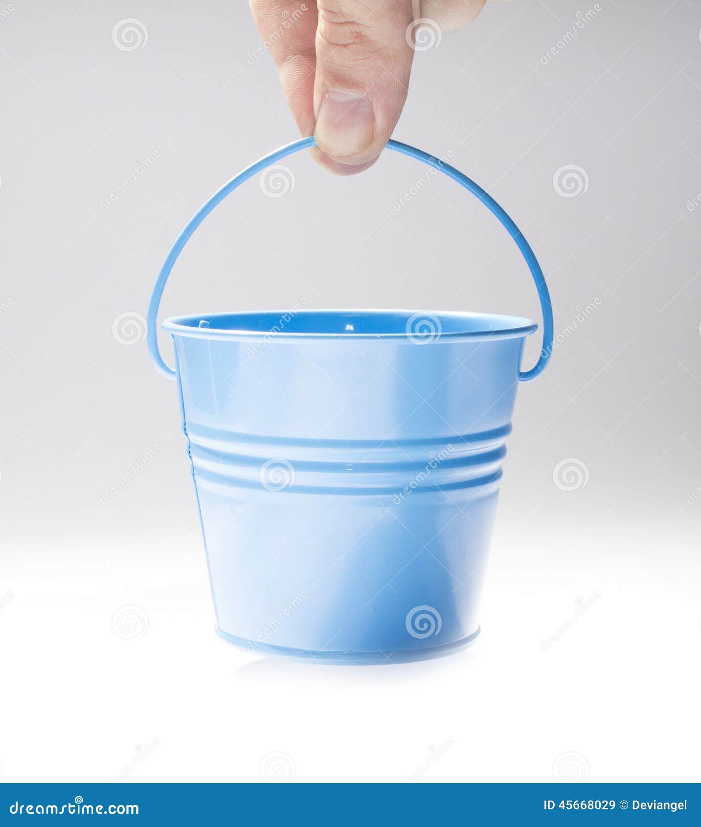 Hand holding a bucket stock image. Image of tray, shiny - 45668029