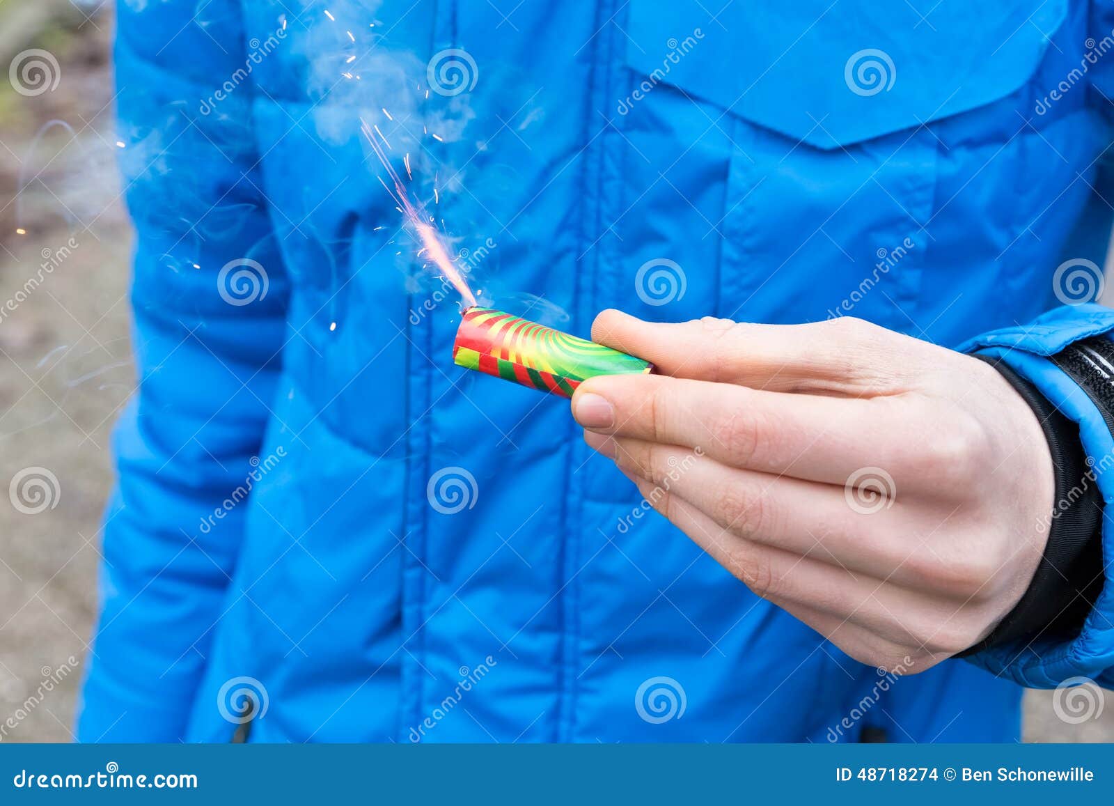 Hand Holding Burning Firework in Front of Blue Jacket Stock Photo ...