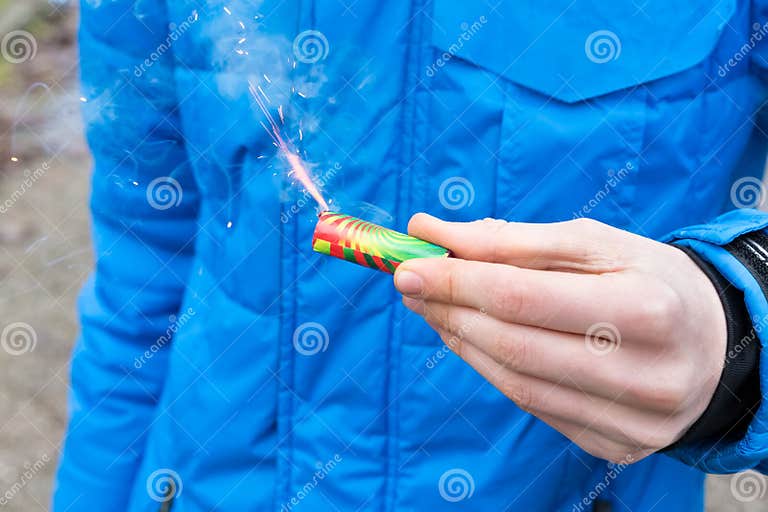 Hand Holding Burning Firework in Front of Blue Jacket Stock Photo ...