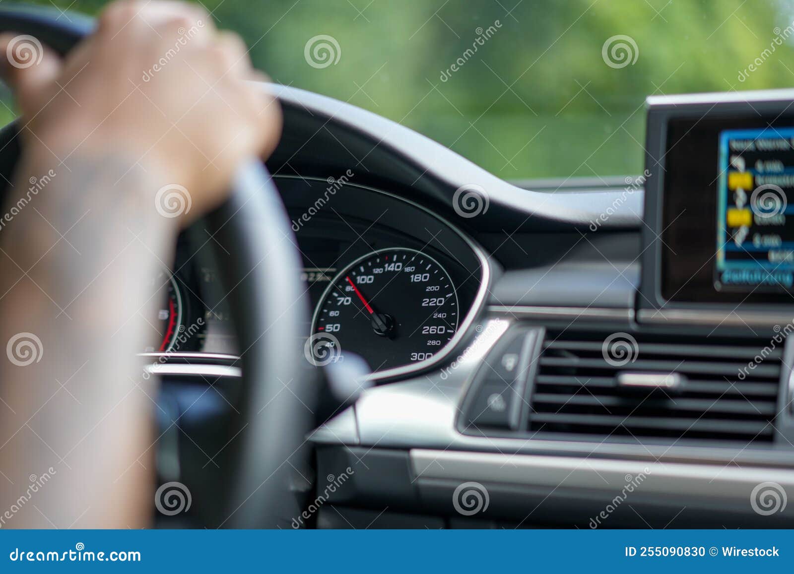 Hand Holding the Car Steering Wheel while Driving with Car Speedometer ...