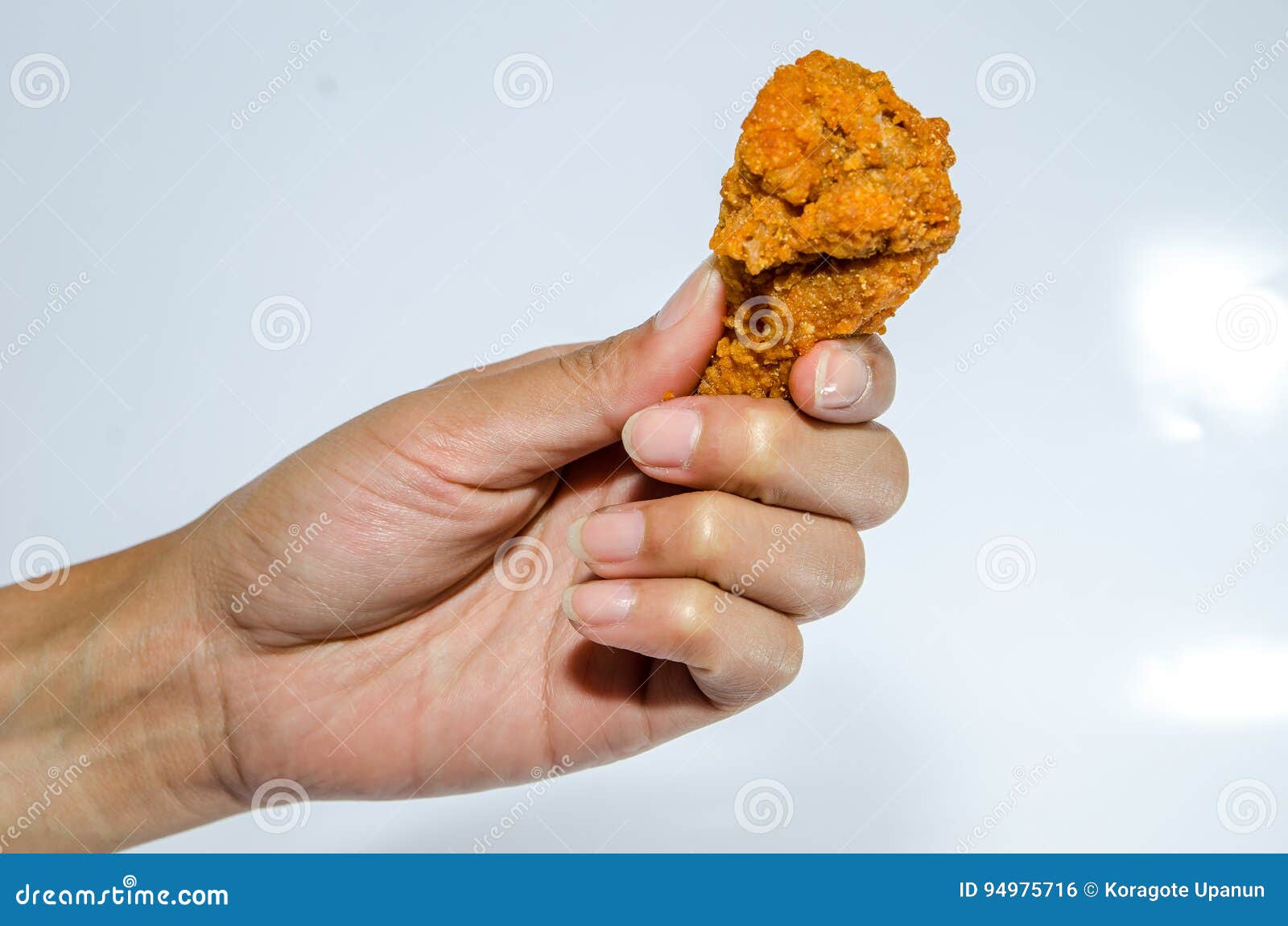 Hand holding Chicken Wing stock photo. Image of breaded - 94975716
