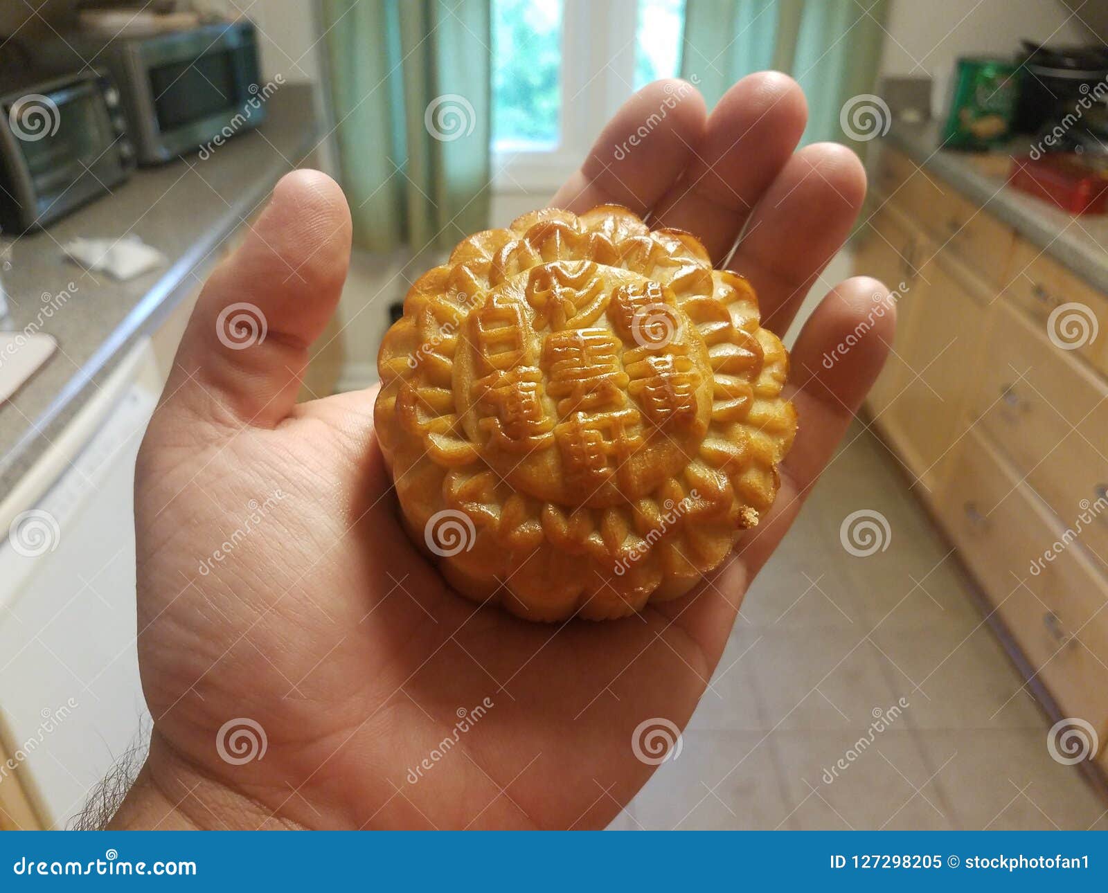 Hand Holding Chinese Moon Cake Pastry in a Kitchen Stock Image - Image ...