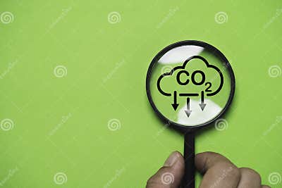 Hand Holding CO2 Reducing Icon Inside Magnifier Glass for Focusing ...