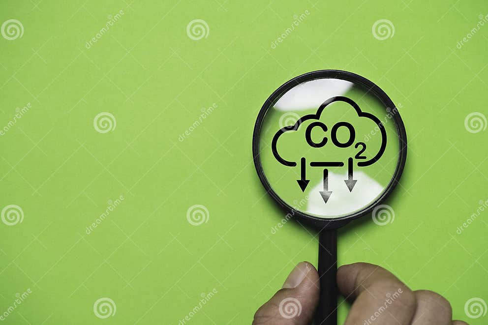 Hand Holding CO2 Reducing Icon Inside Magnifier Glass for Focusing ...
