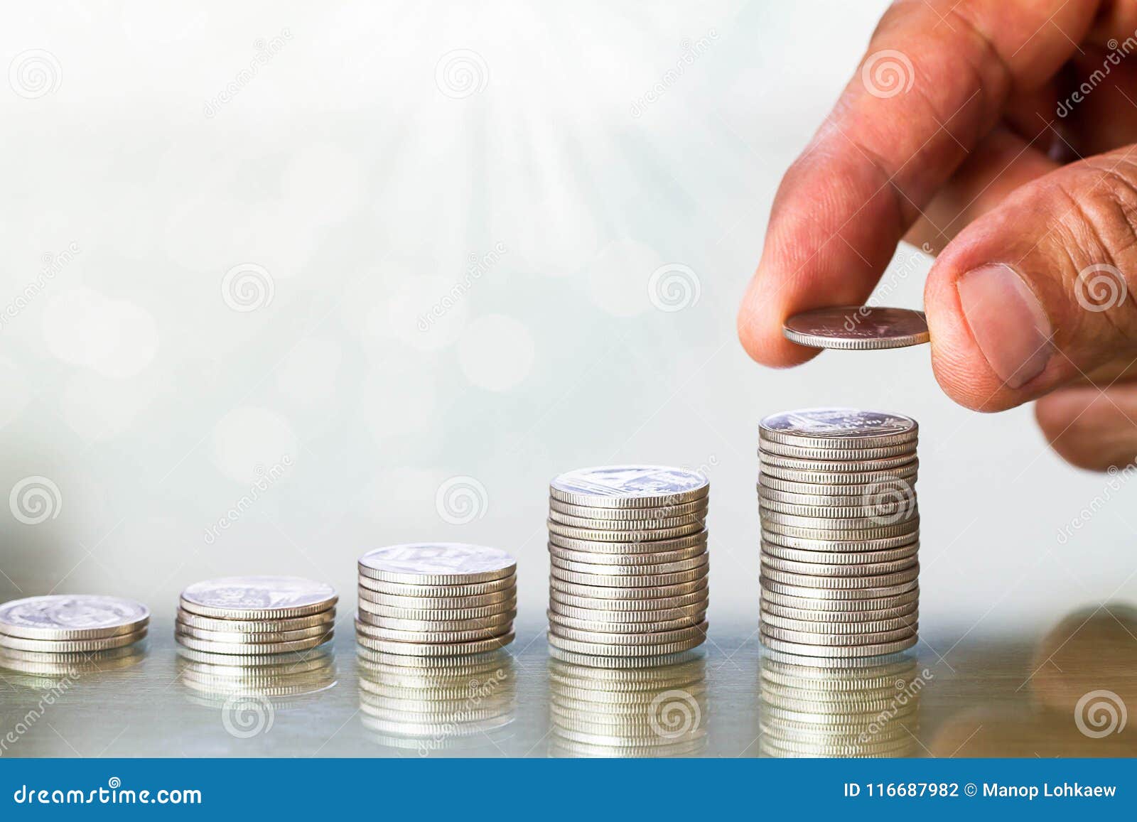 Hand Holding Coin Putting on Top of Coin`s Stack Stock Photo - Image of ...