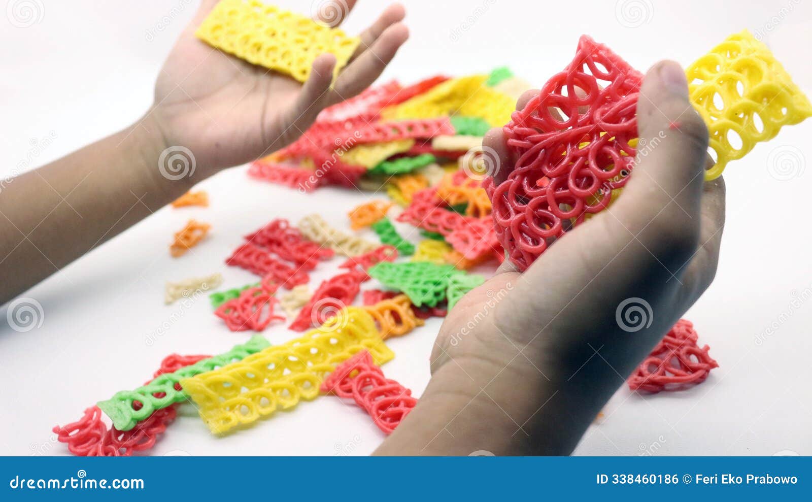 Hand Holding Colorful Crackers or Krupuk Unfired Isolated Stock Photo ...