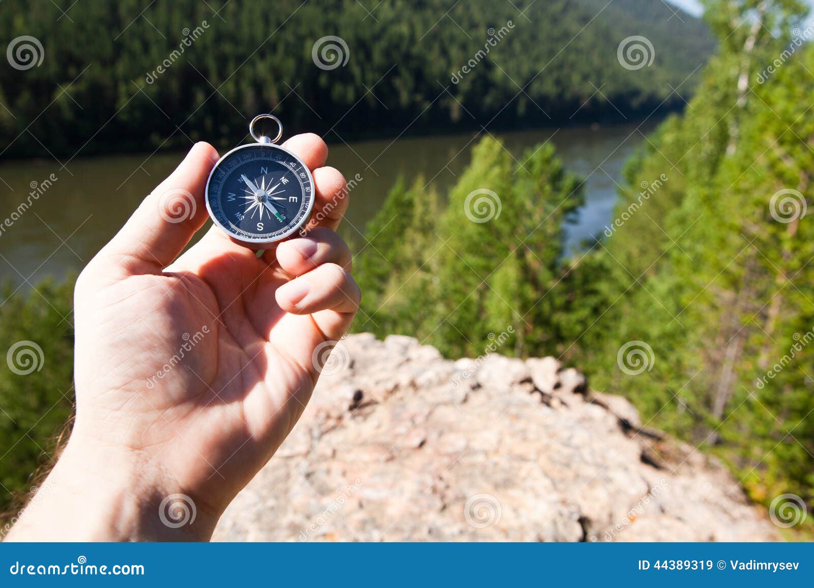 Hand holding the compass stock image. Image of hike, landscape - 44389319
