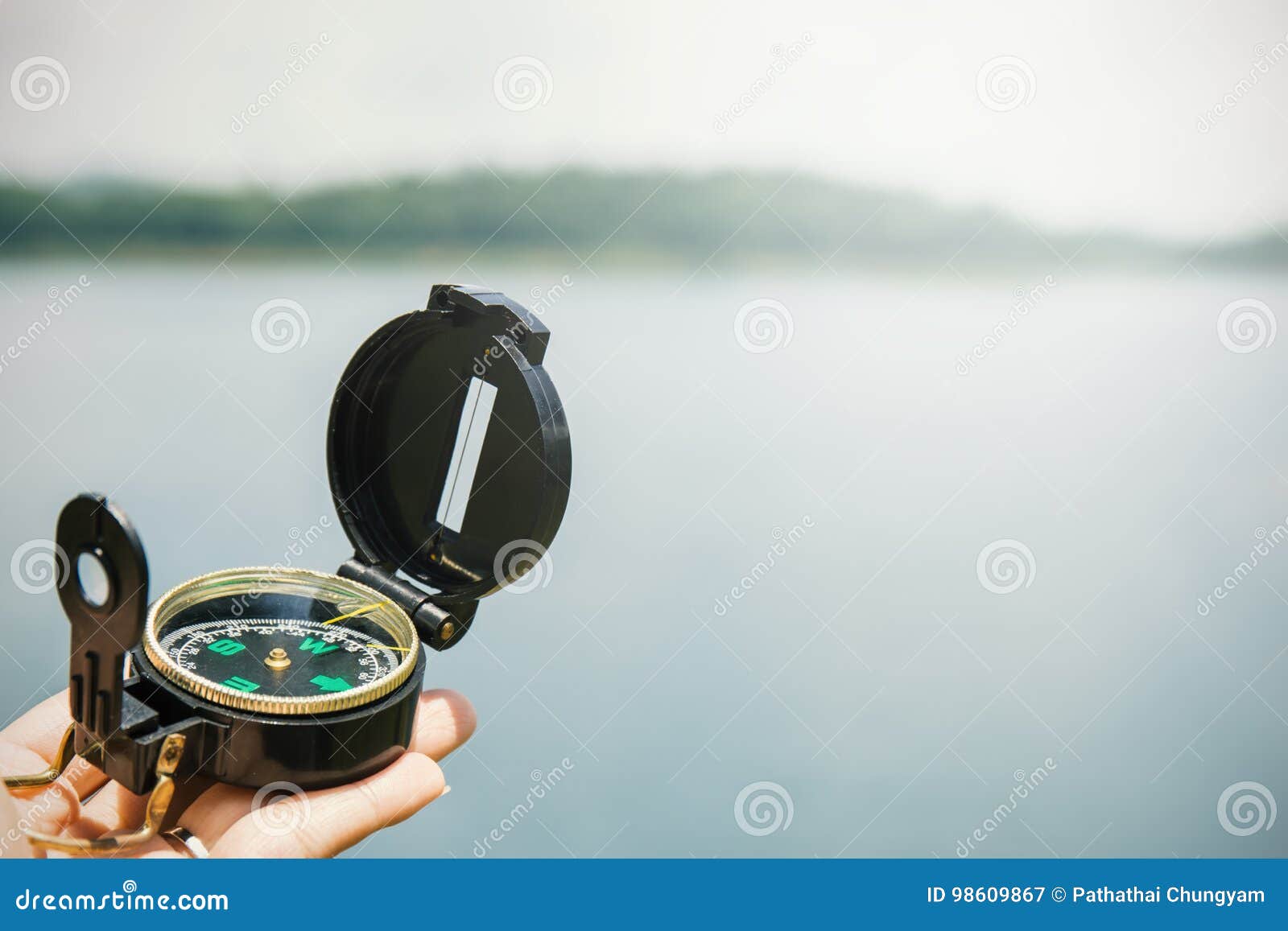 Hand Holding Compass Over Nature Background Stock Image - Image of east ...