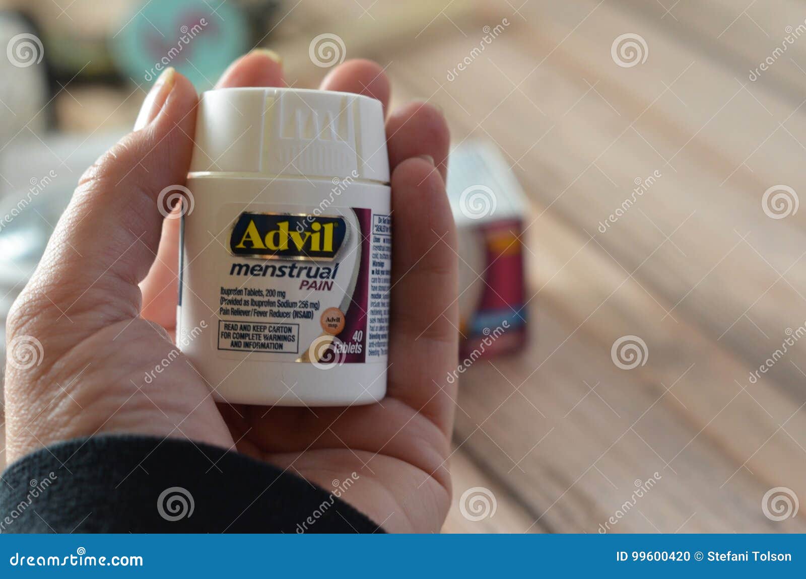 Container of Advil editorial image. Image of hand, holding - 99600420