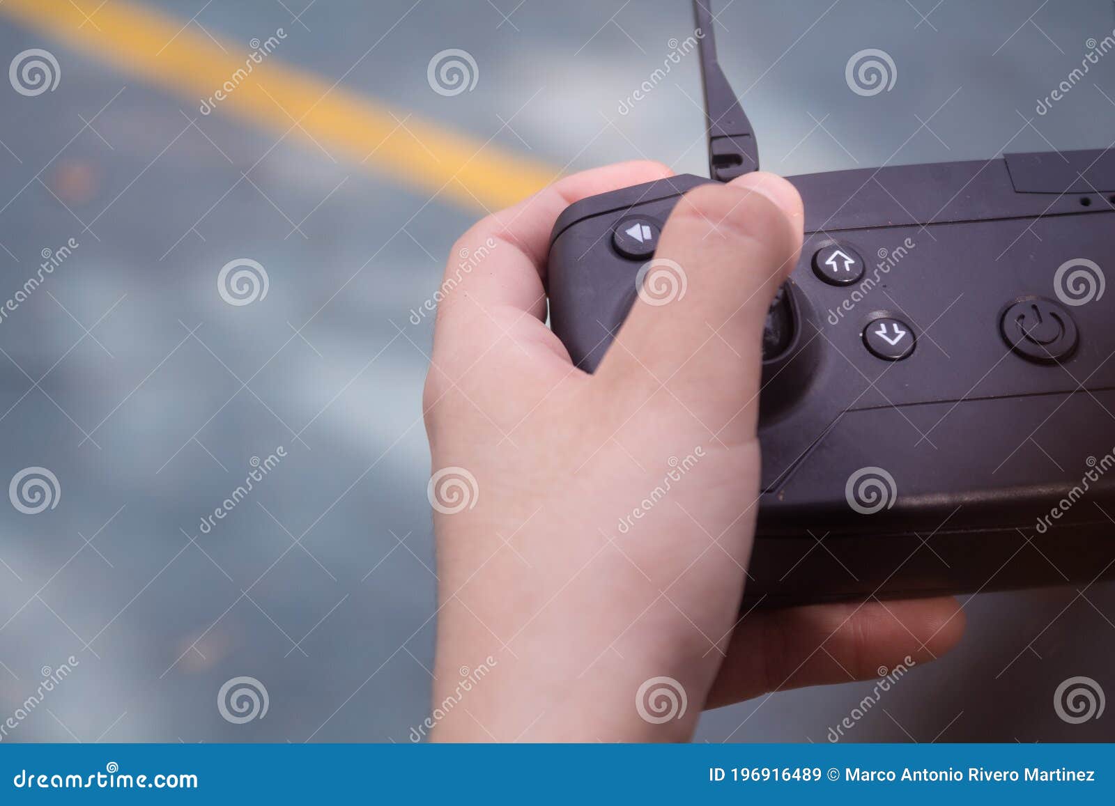 A hand holding a control stock image. Image of field - 196916489