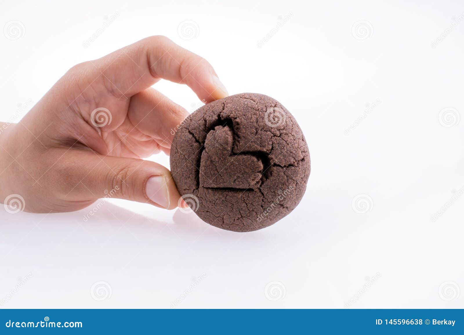 Hand holding a cookie stock photo. Image of delicious - 145596638