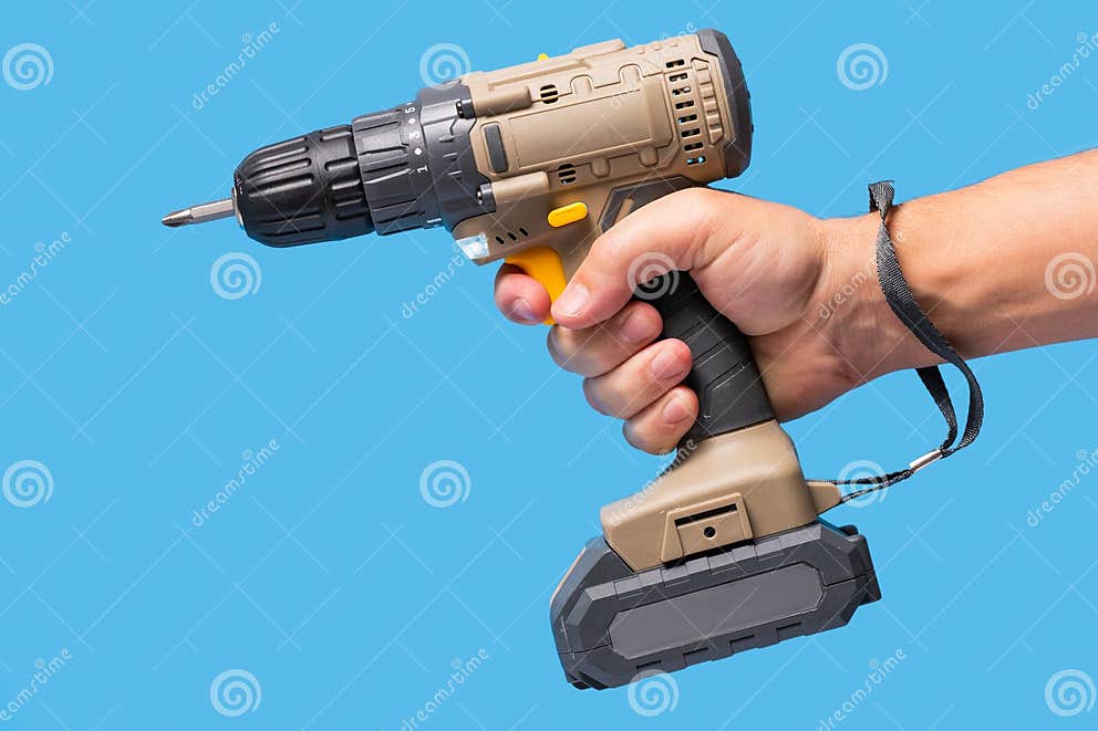 Hand Holding Cordless Drill on Blue Background with Copy Space Stock ...