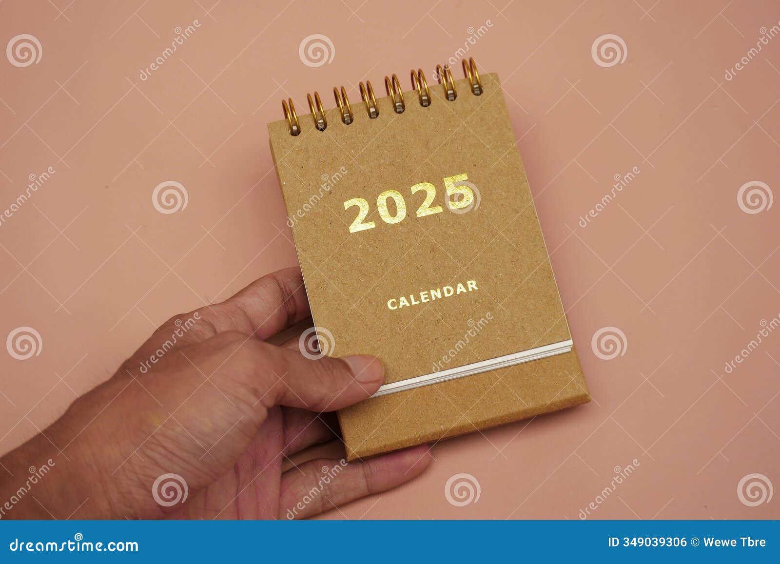 A Hand Holding a Desk Calendar for 2025 Stock Photo - Image of annual ...