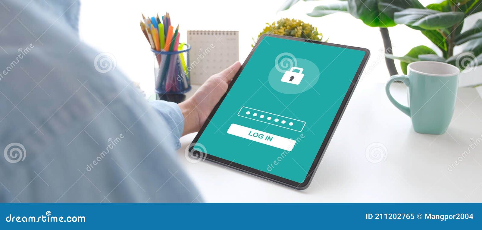 Hand Holding Digital Tablet with Password Login on Screen at Working ...