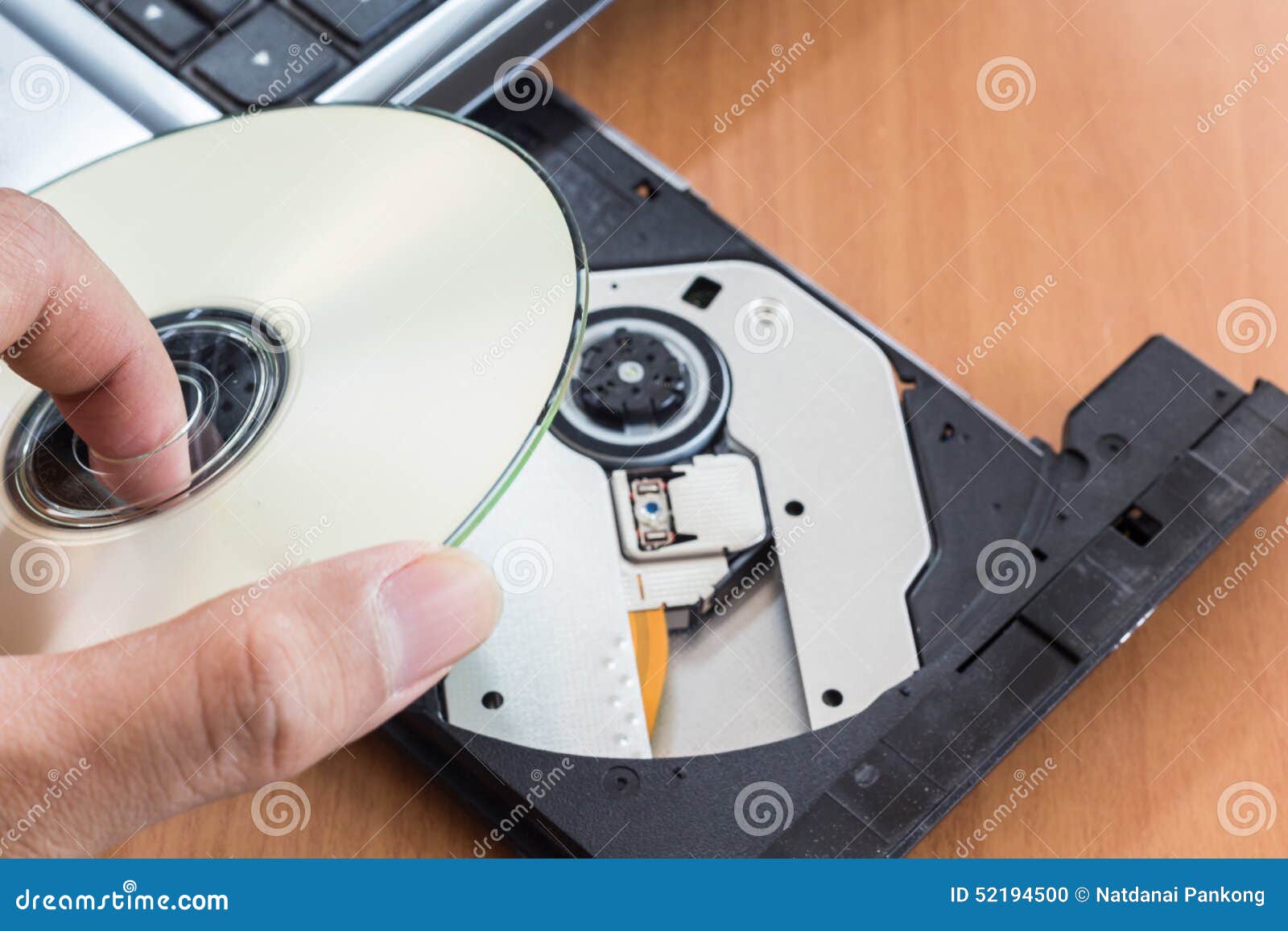 Hand Holding Disk Insert To Laptop Stock Photo - Image of hand ...