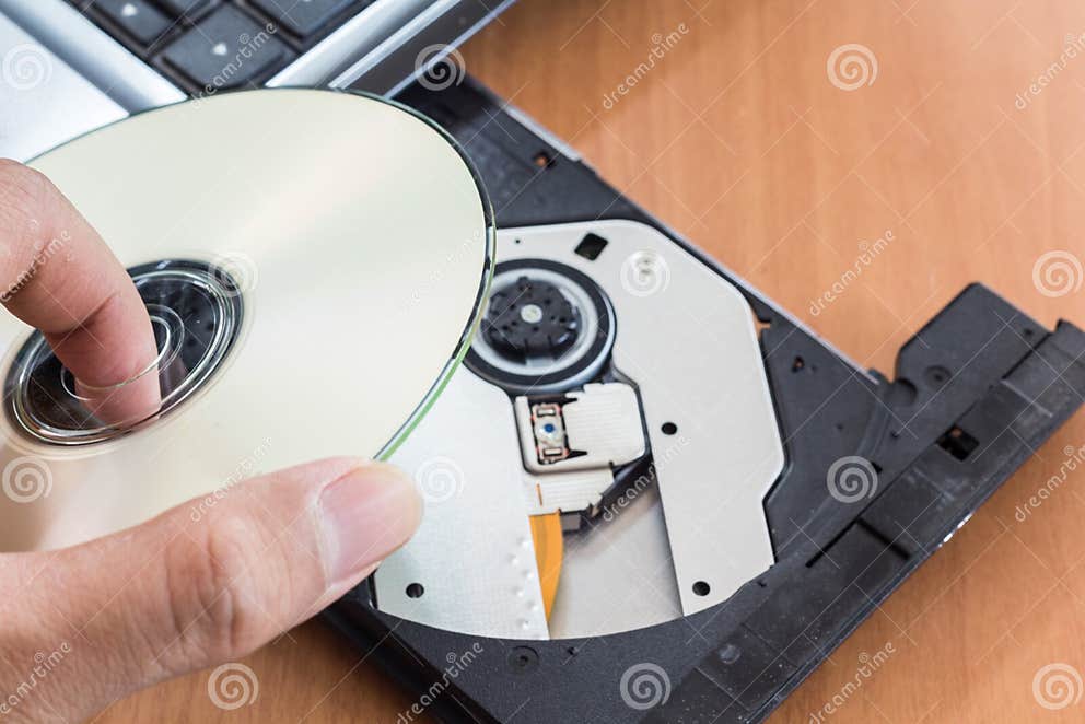 Hand Holding Disk Insert To Laptop Stock Photo - Image of hand ...