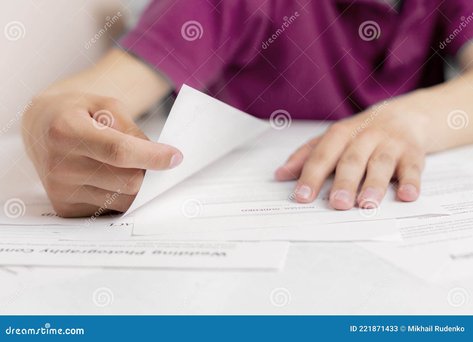 A Hand Holding a Document Sheet, Doing Some Paper Work in the Office ...